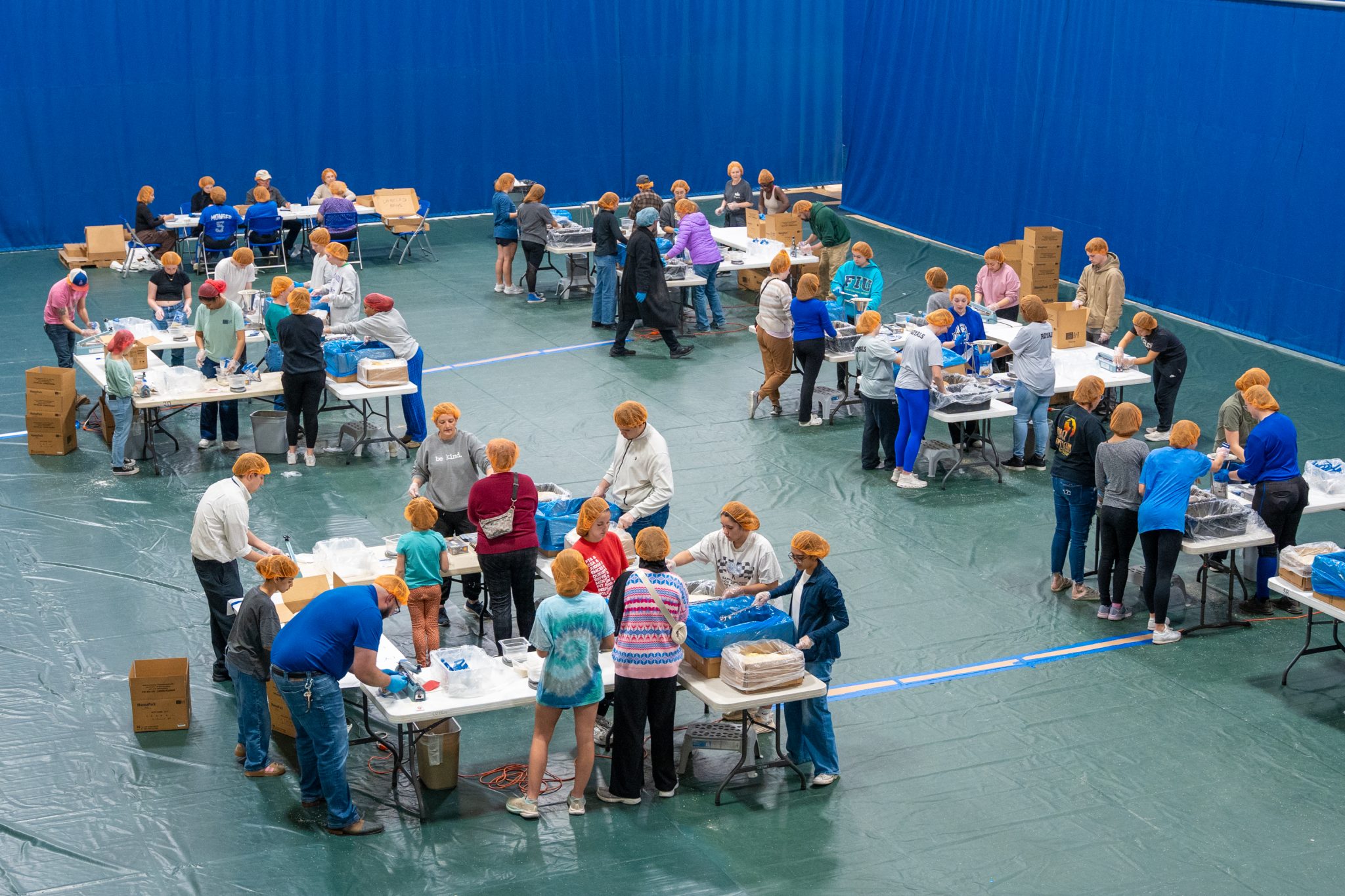 Volunteers pack 113K meals at EMU for hungry children around the world ...