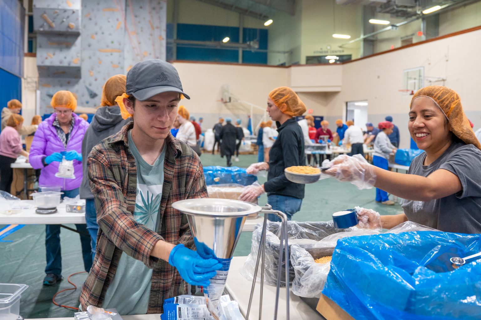 Volunteers pack 113K meals at EMU for hungry children around the world ...